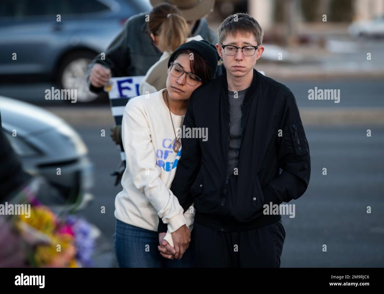 Chas Garcia, left, and Niamh Anderson, right, hold hands in front of a memorial outside of Club ...