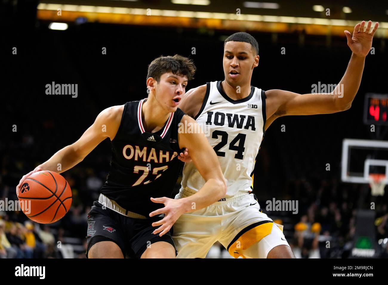 Omaha forward Frankie Fidler (23) drives past Iowa forward Kris Murray ...