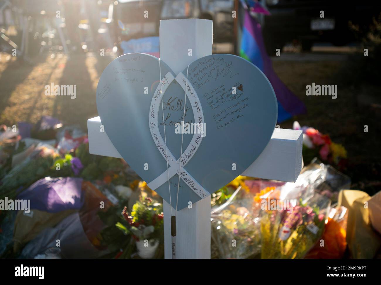 The sun shines on a cross for Kelly Loving, one of the victims of the ...