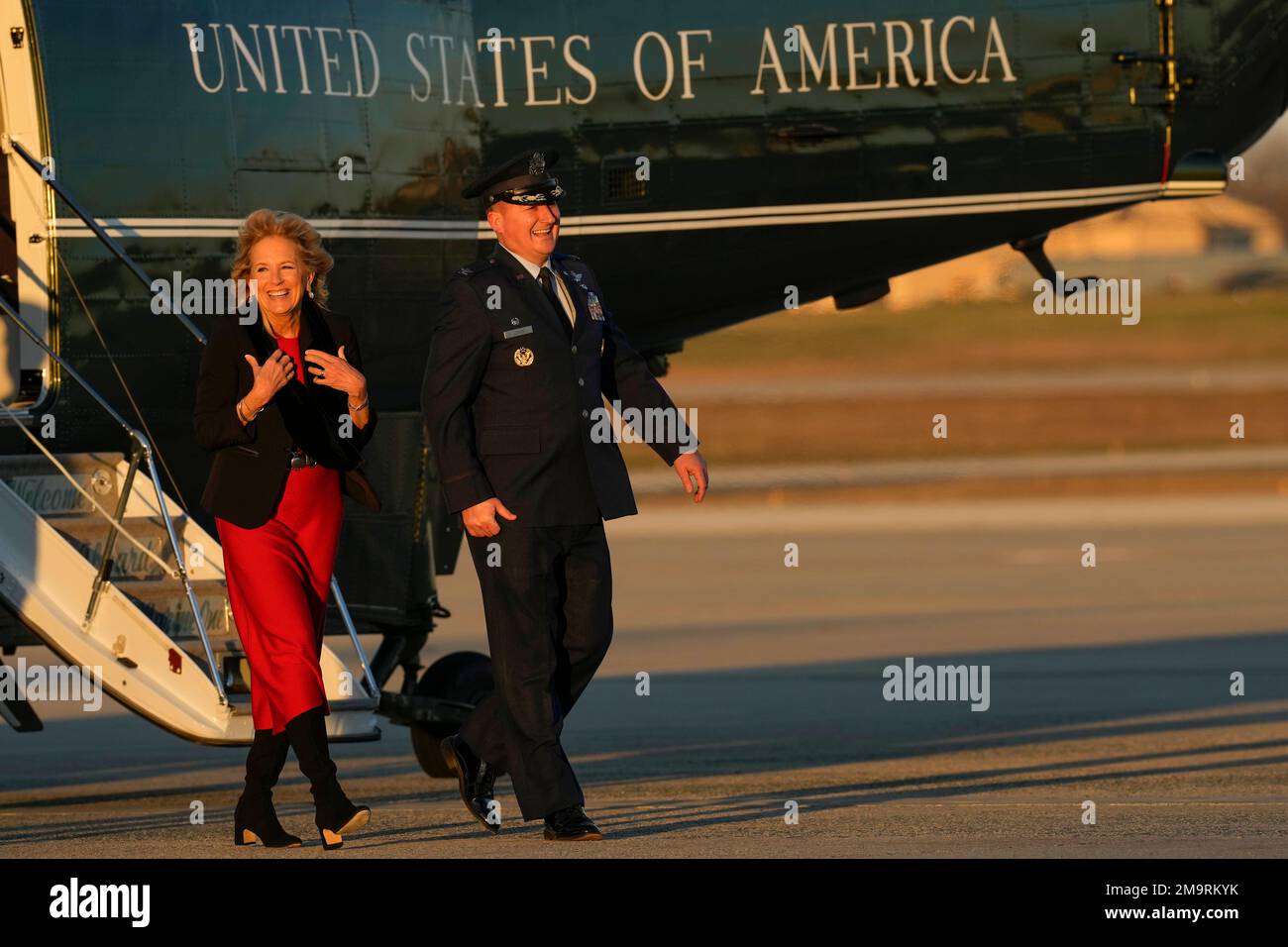 First lady Jill Biden walks with Col. Matthew Jones, commander of the ...