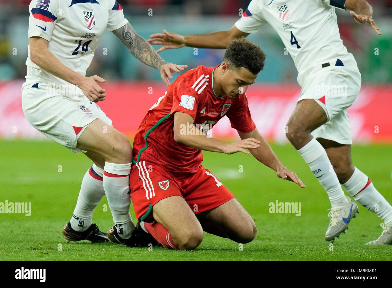 Wales' Ethan Ampadu is tackled by Josh Sargent, left, and Tyler Adams ...