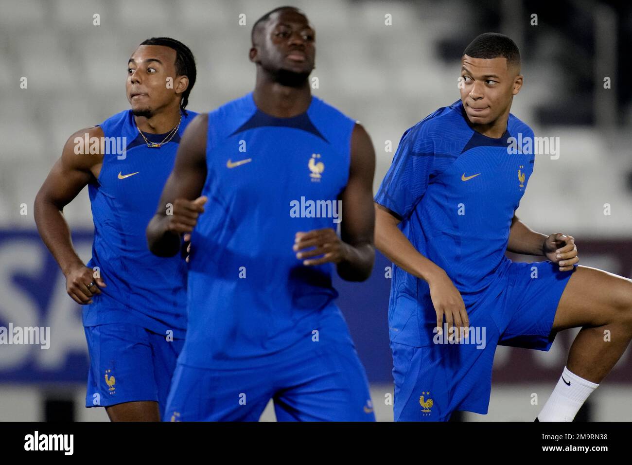 France's Jules Kounde, left, and France's Kylian Mbappe, right ...