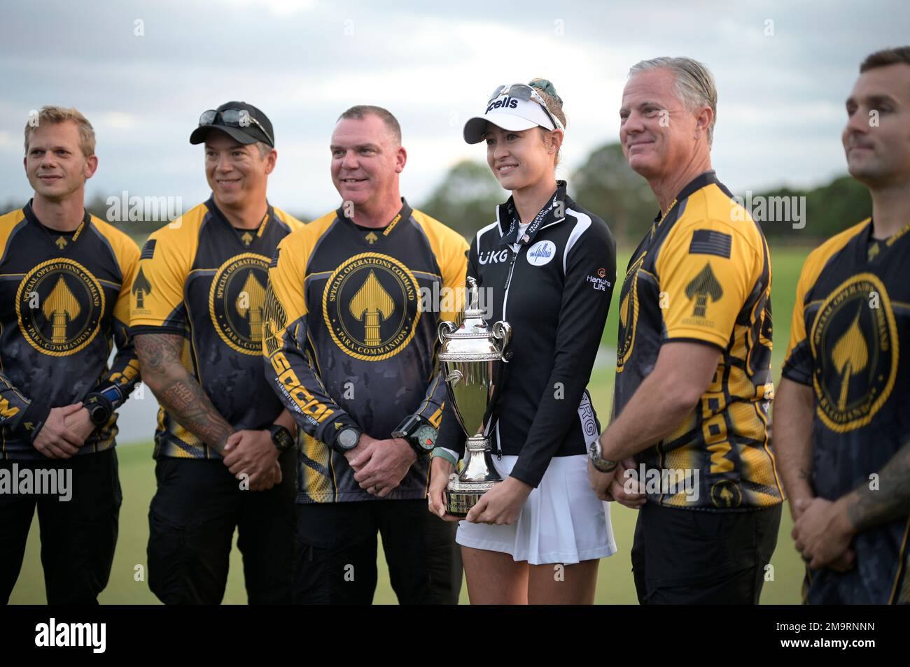Nelly Korda, center, holds the championship trophy, while posing for a ...