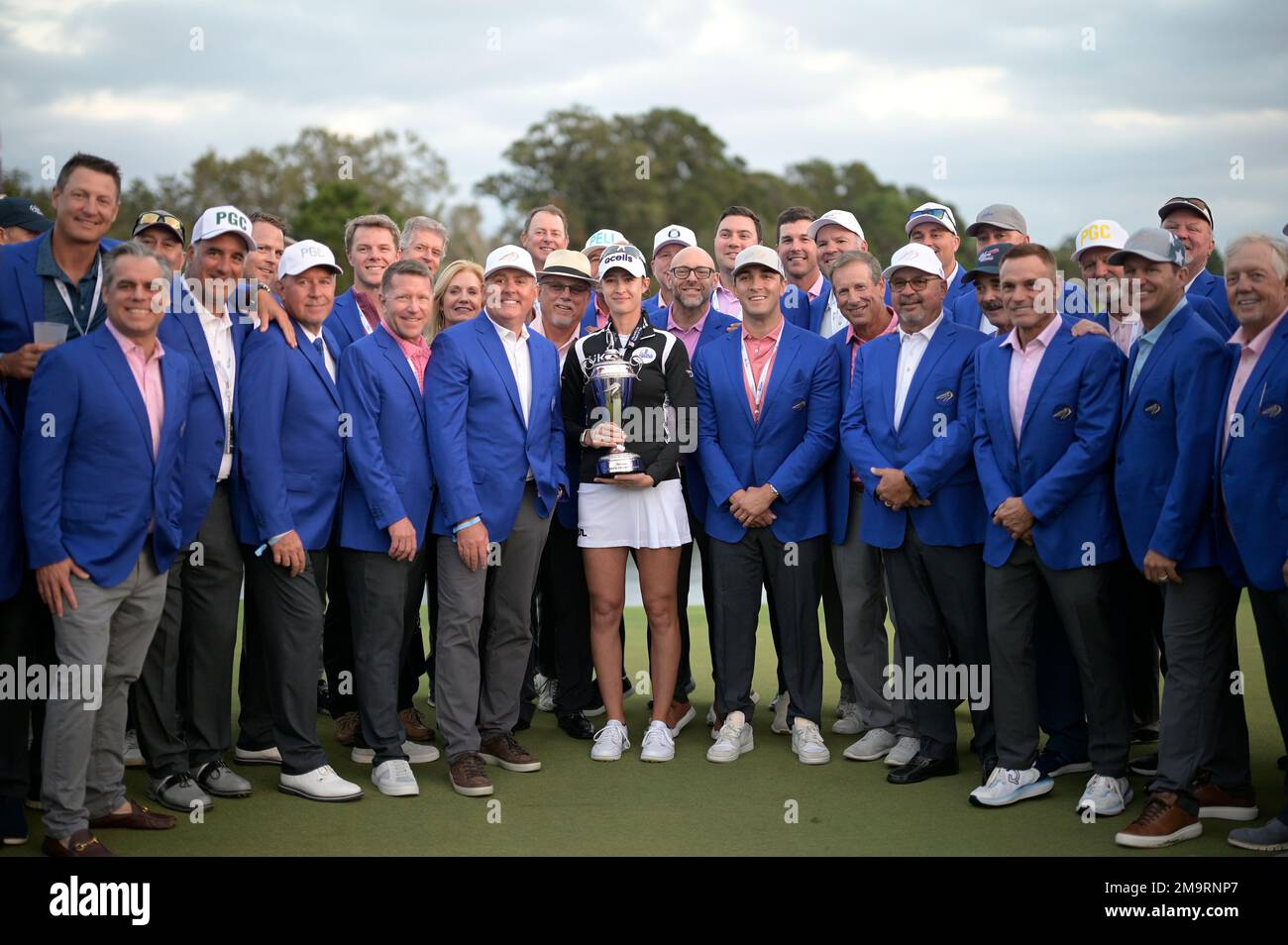 Nelly Korda, center, holds the championship trophy, while posing with ...