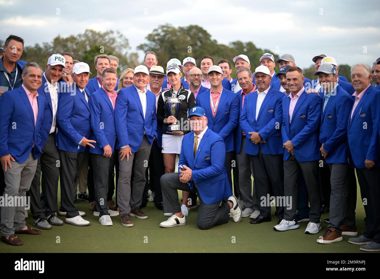 Nelly Korda, center, holds the championship trophy, while posing with ...