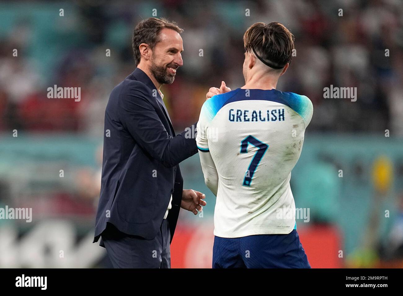 England's Jack Grealish, right, celebrates with coach Gareth Southgate ...
