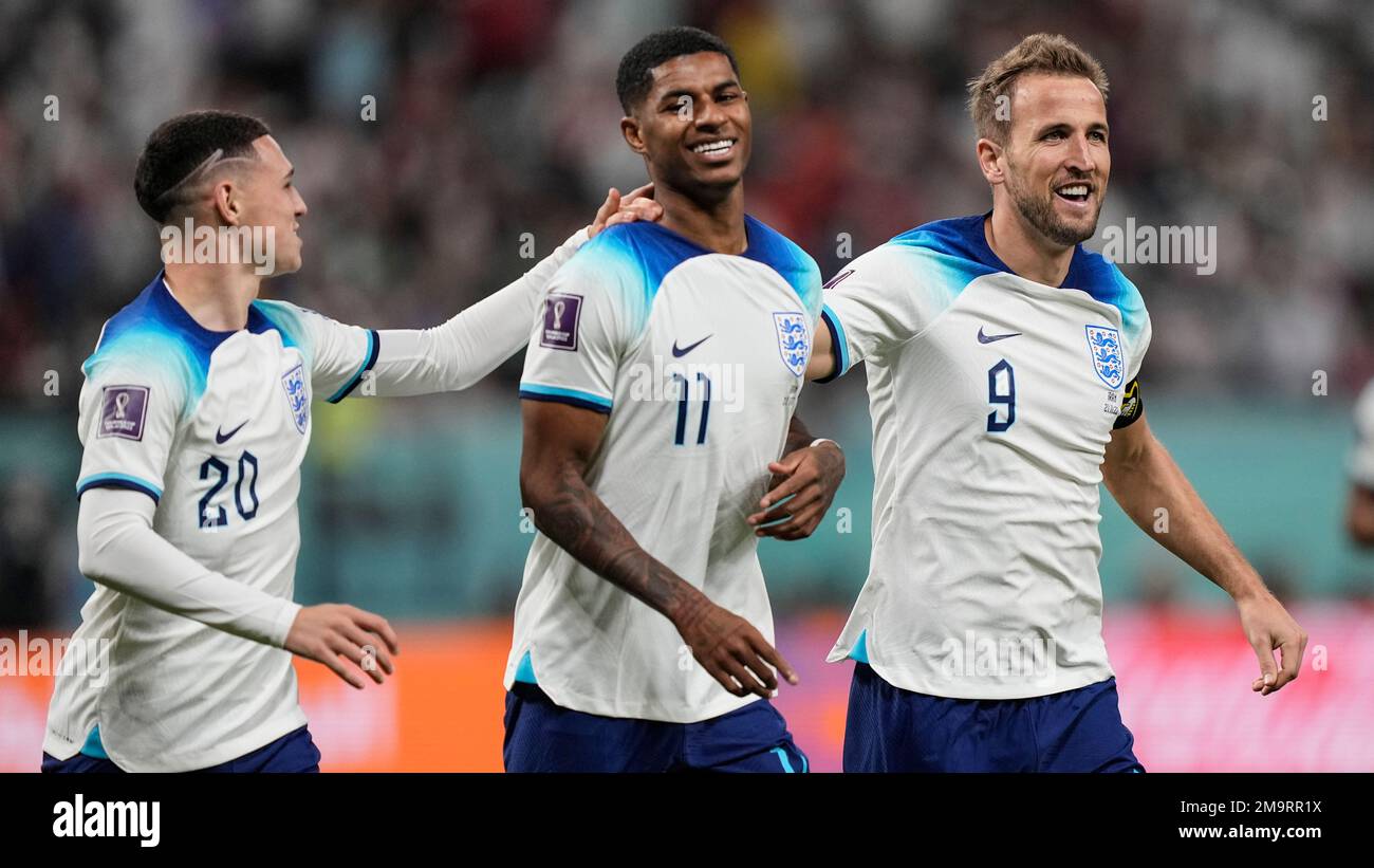 England's Marcus Rashford, second left, is congratulated by teammates ...