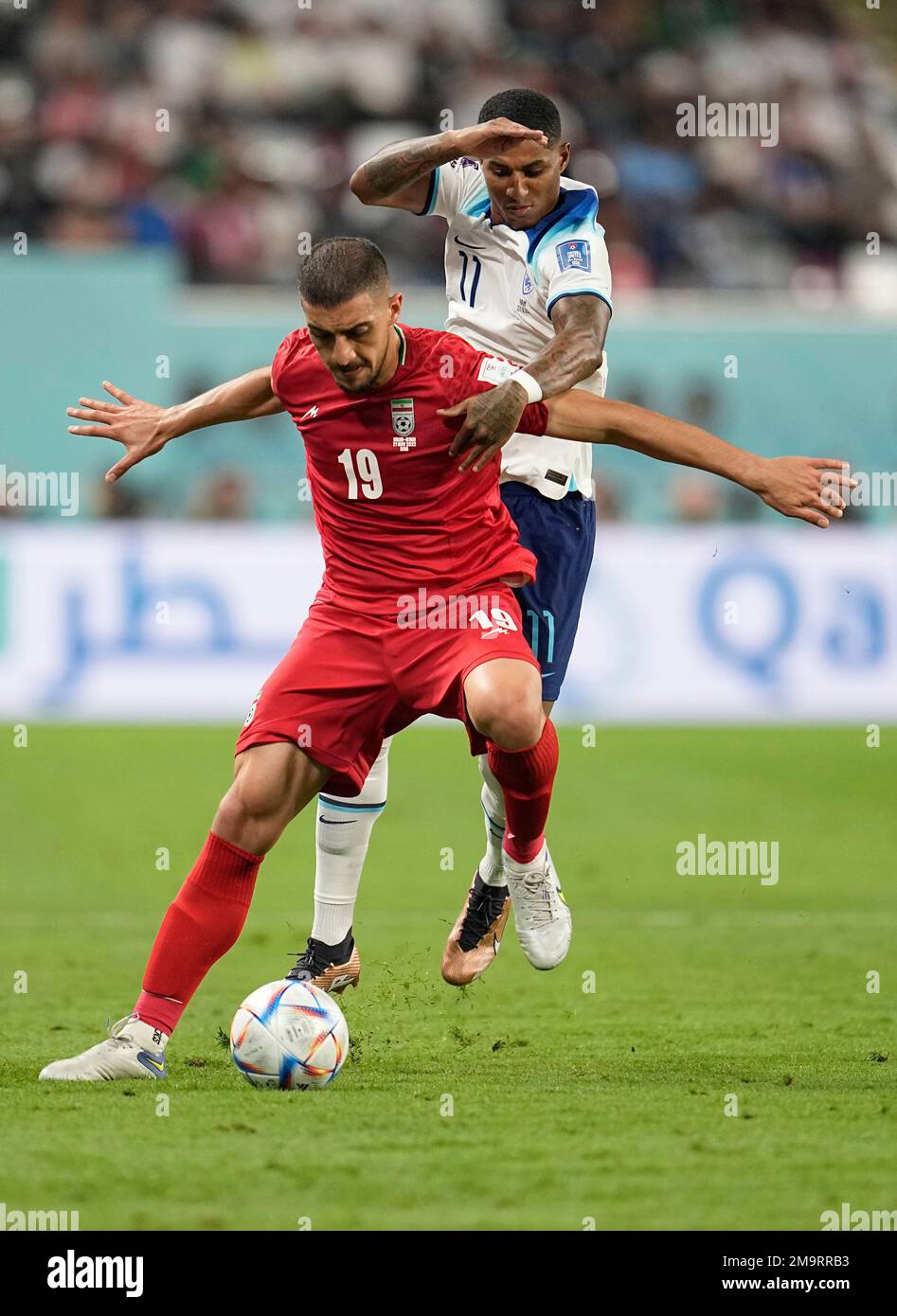 Iran's Majid Hosseini, left, and England's Marcus Rashford fight for ...