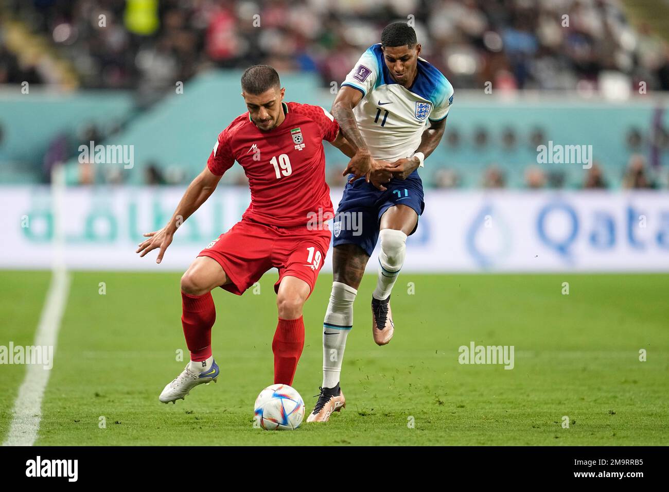 Iran's Majid Hosseini, left, and England's Marcus Rashford fight for ...