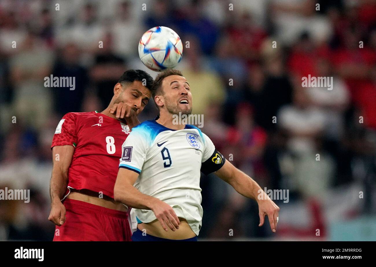 England's Harry Kane, right, jumpss for the ball with Iran's Morteza ...