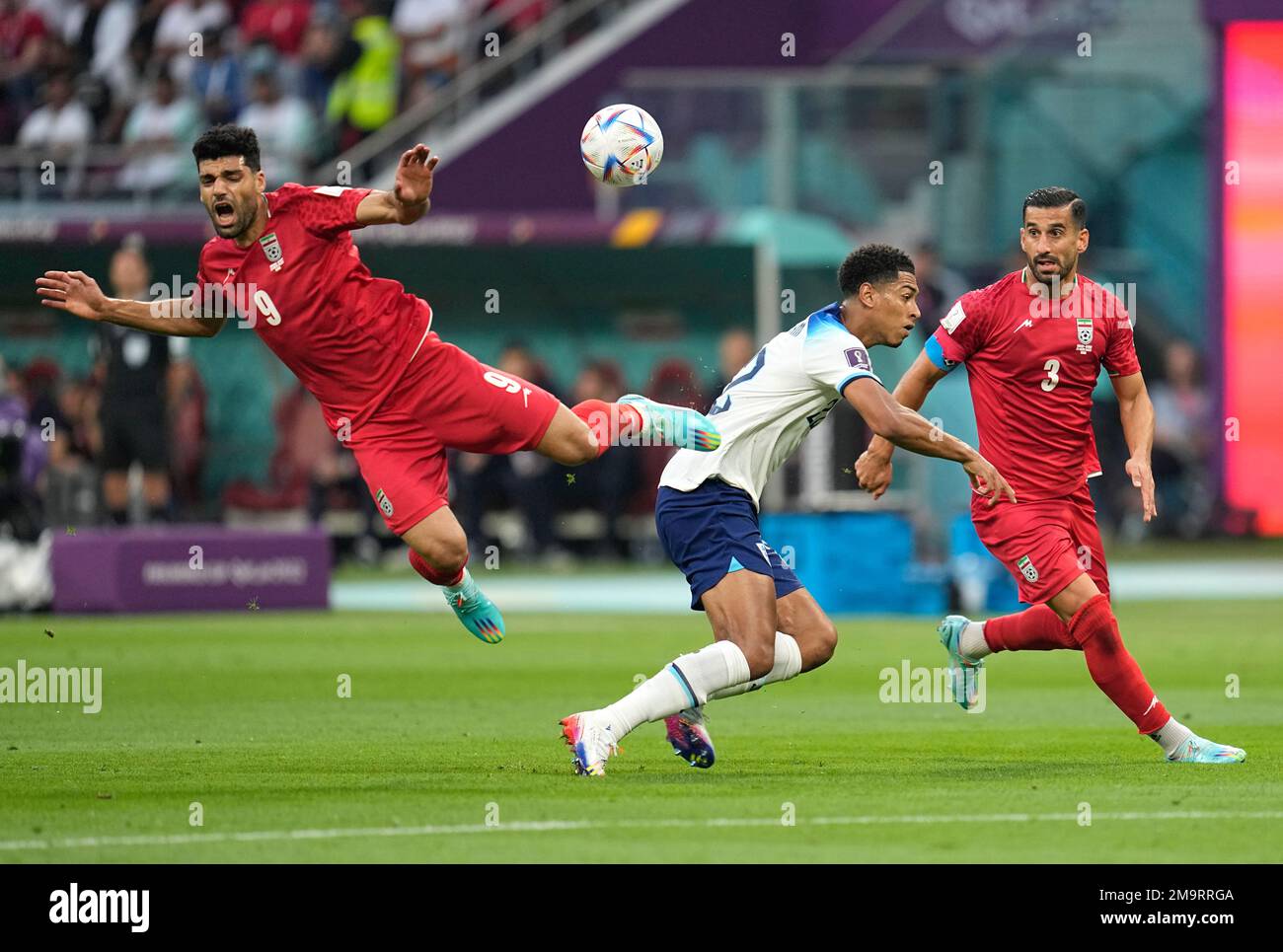 Iran's Mehdi Taremi, left, and England's Jude Bellingham, center ...