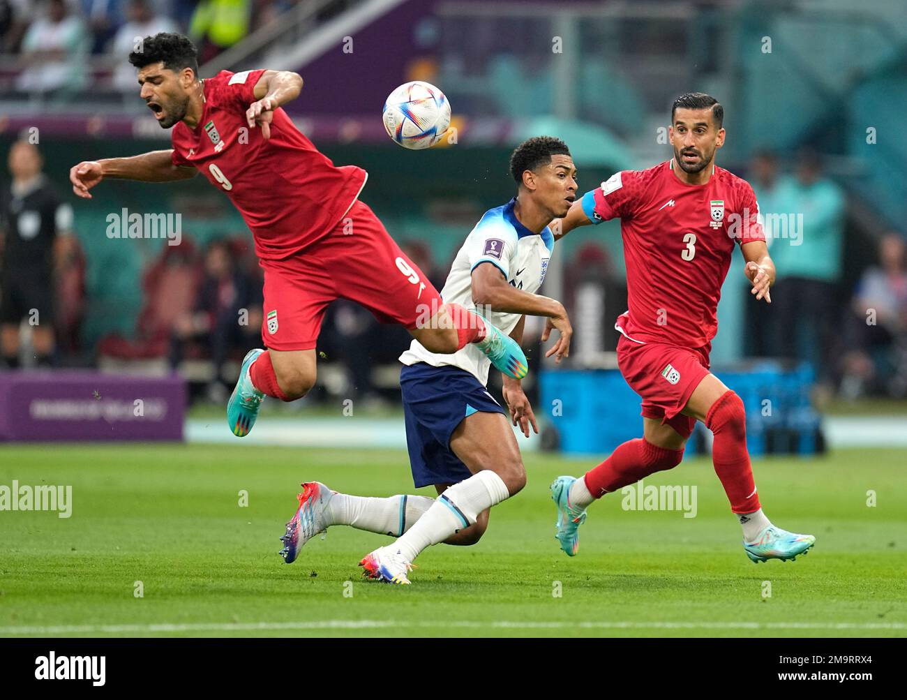 Iran's Mehdi Taremi, left, and England's Jude Bellingham, center ...