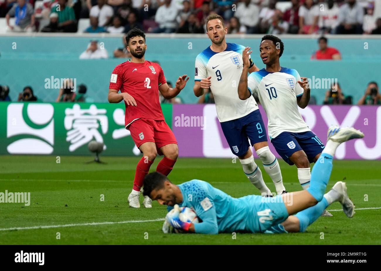 Iran's Abolfazl Jalali, front, makes a save in front of England's ...
