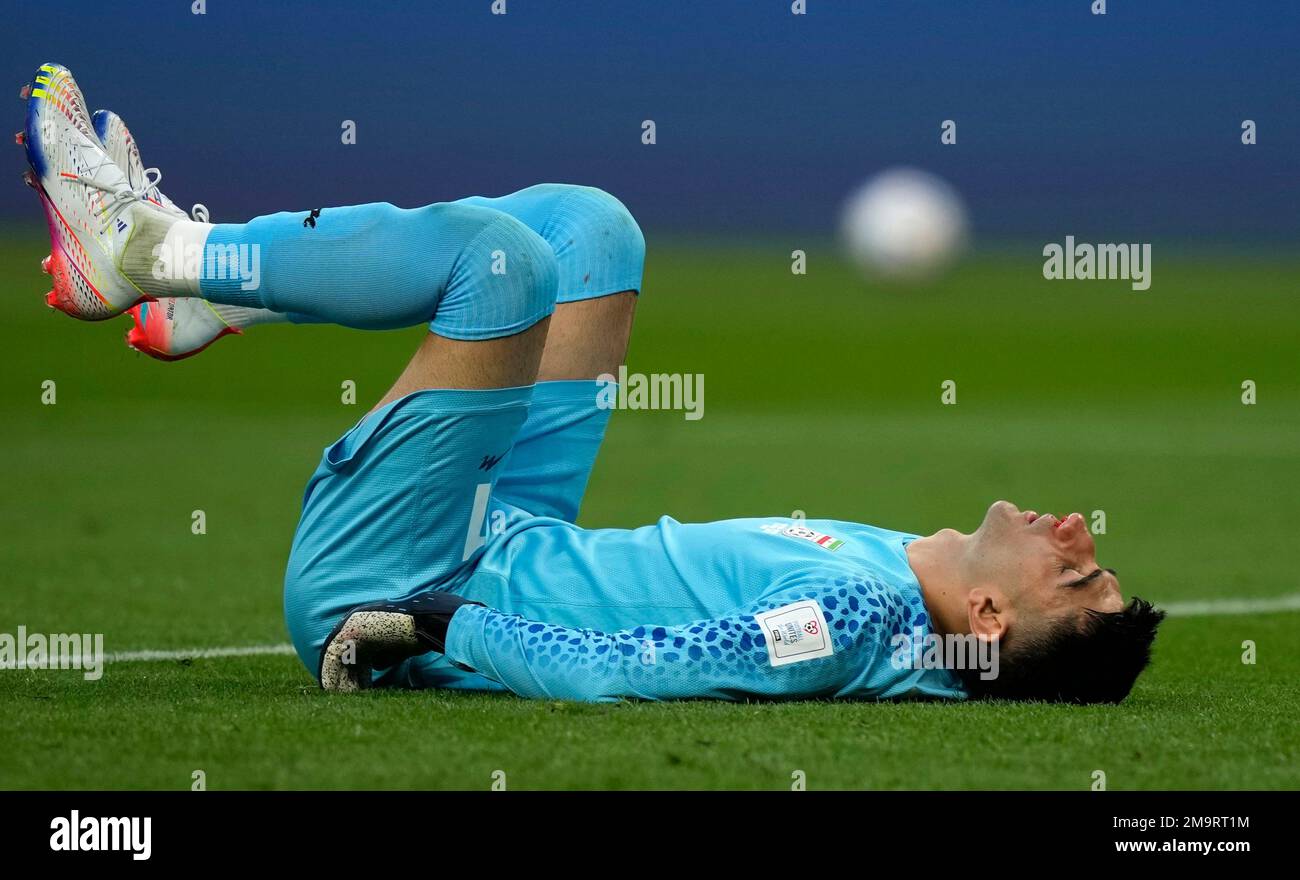 Iran's goalkeeper Alireza Beiranvand reacts after sustaining an injury ...