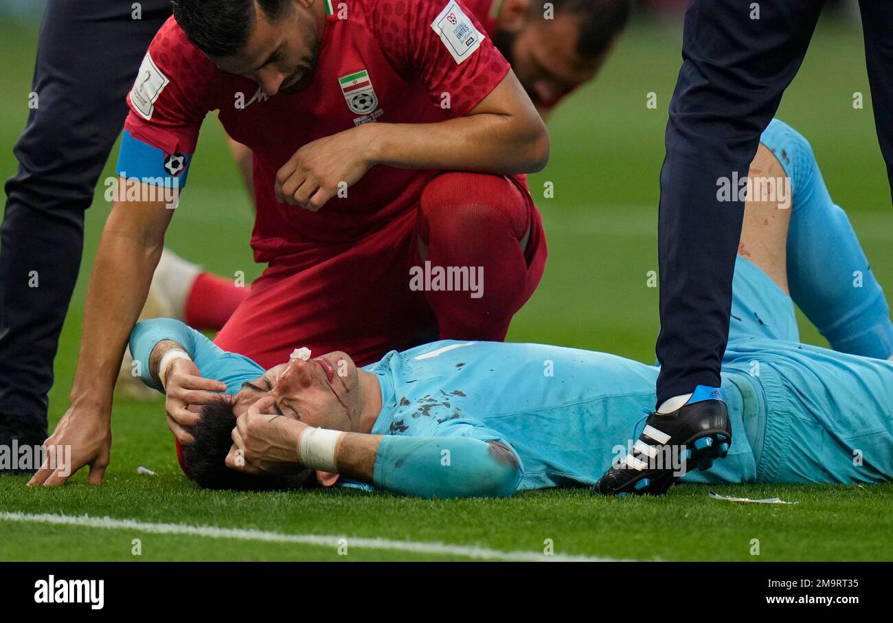 Iran's goalkeeper Alireza Beiranvand reacts after sustaining an injury ...