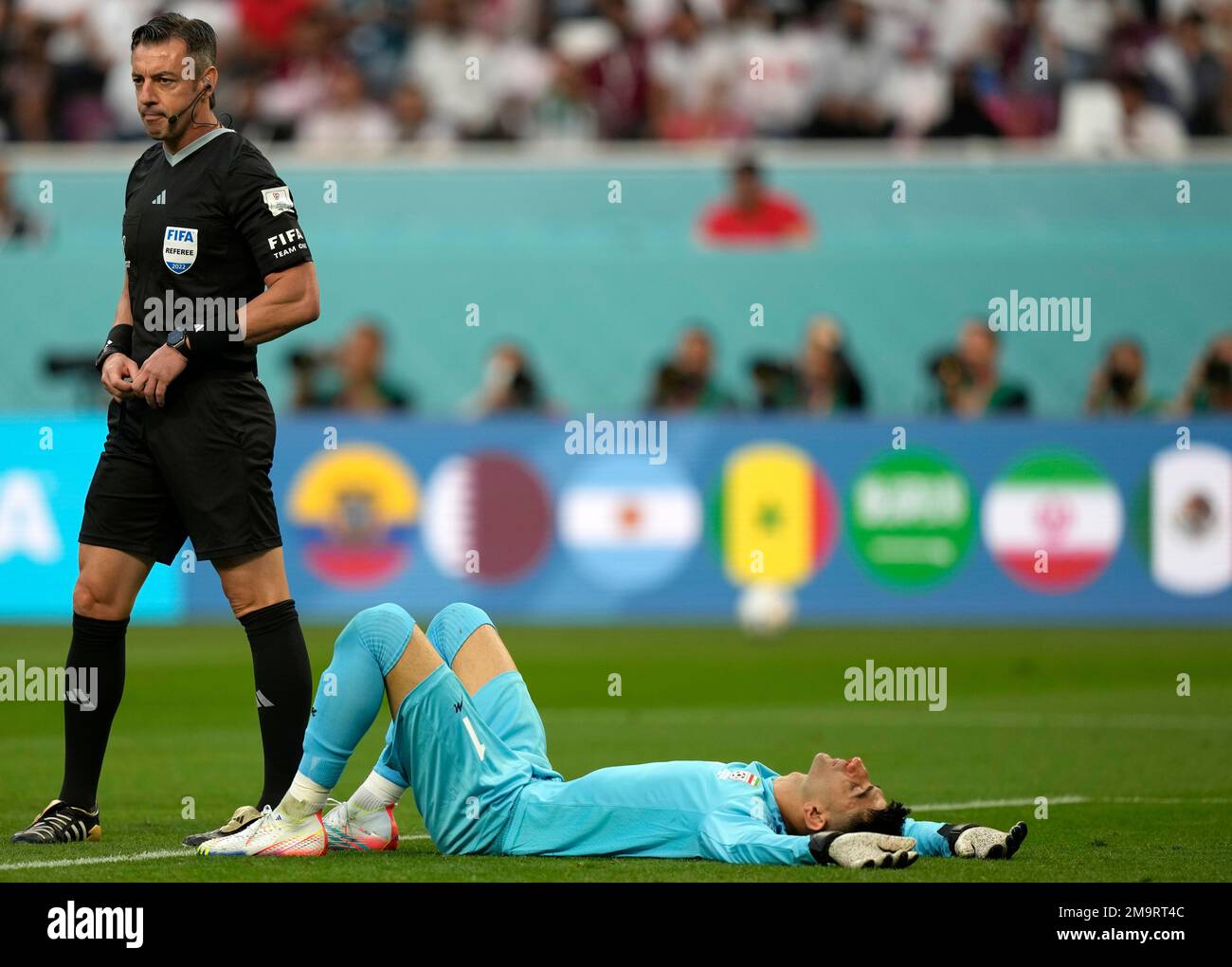 Iran's goalkeeper Alireza Beiranvand reacts after sustaining an injury ...