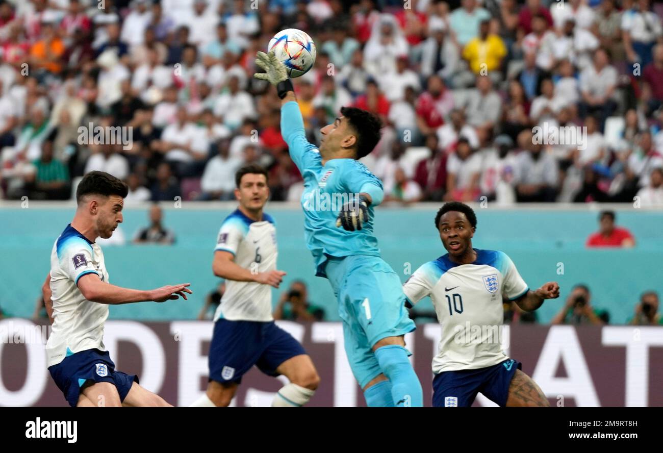 Iran's goalkeeper Alireza Beiranvand, front, makes a save in front of ...
