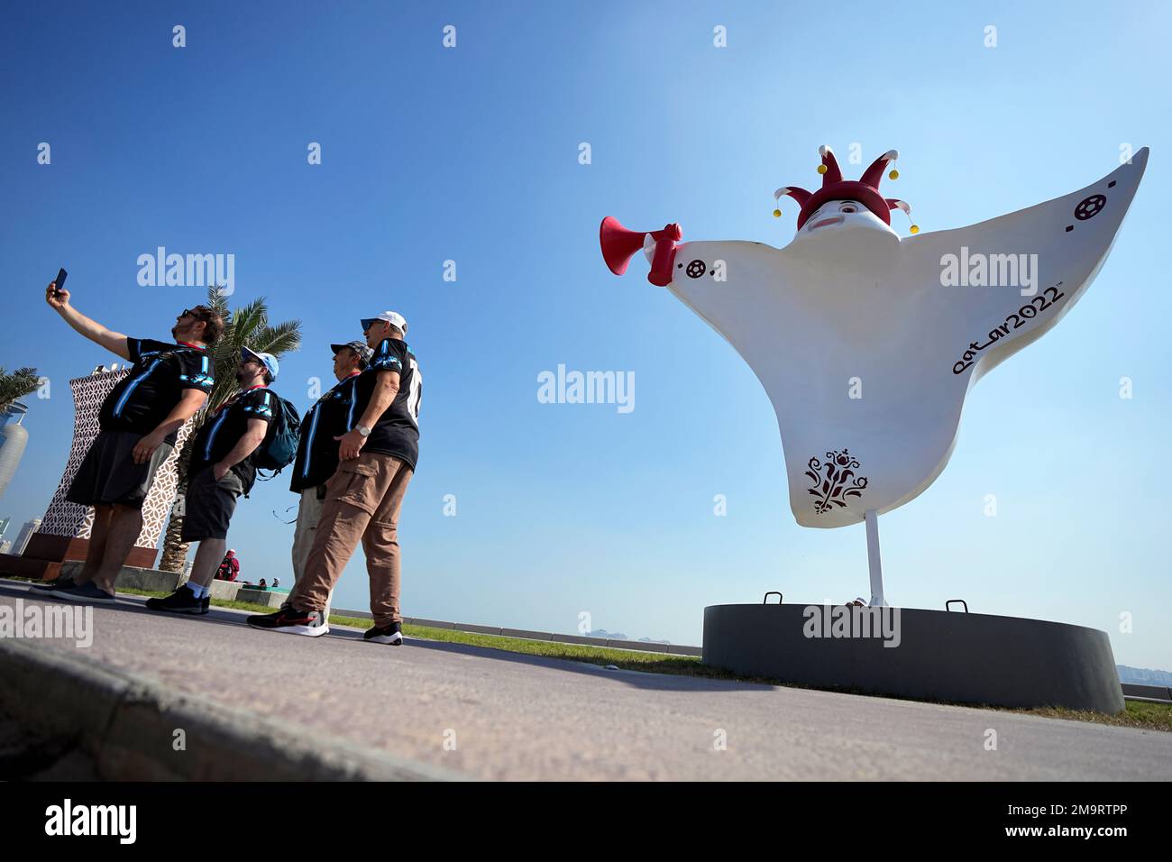 Soccer fans take selfies in front of statue of Qatar 2022 FIFA World ...