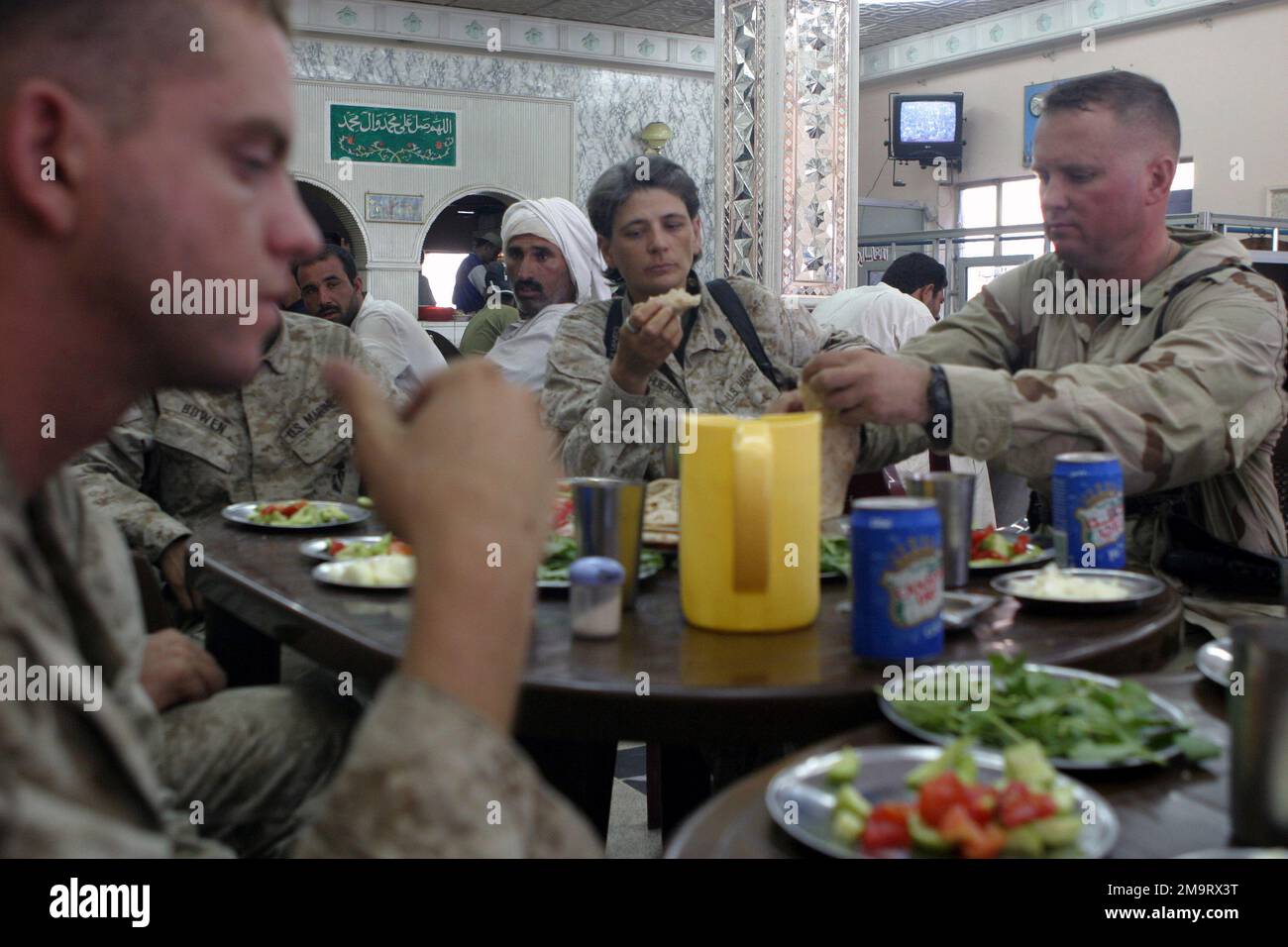 US Marine Corps Reserve (USMCR) Marines eat lunch at a local Iraqi ...