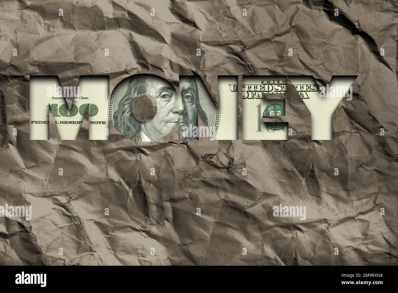 A one-hundred dollar bill is seen through the word money cut into ...