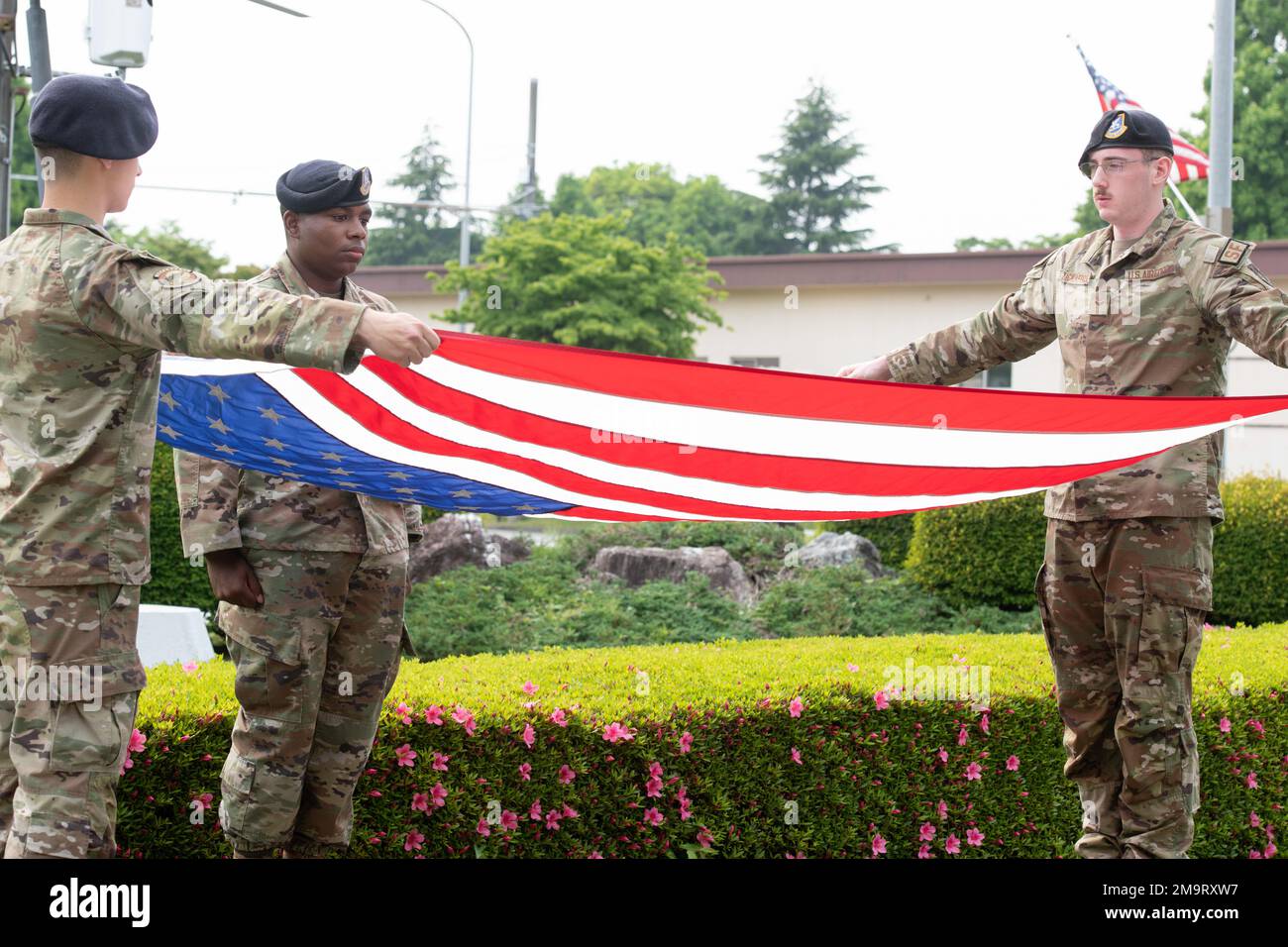 Members of 374th Security Force Squadron begin to fold the American ...
