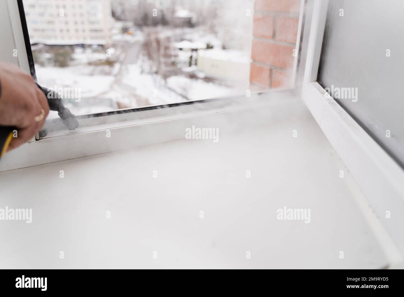 Steam cleaning of window frame at home. Professional cleaner is ...