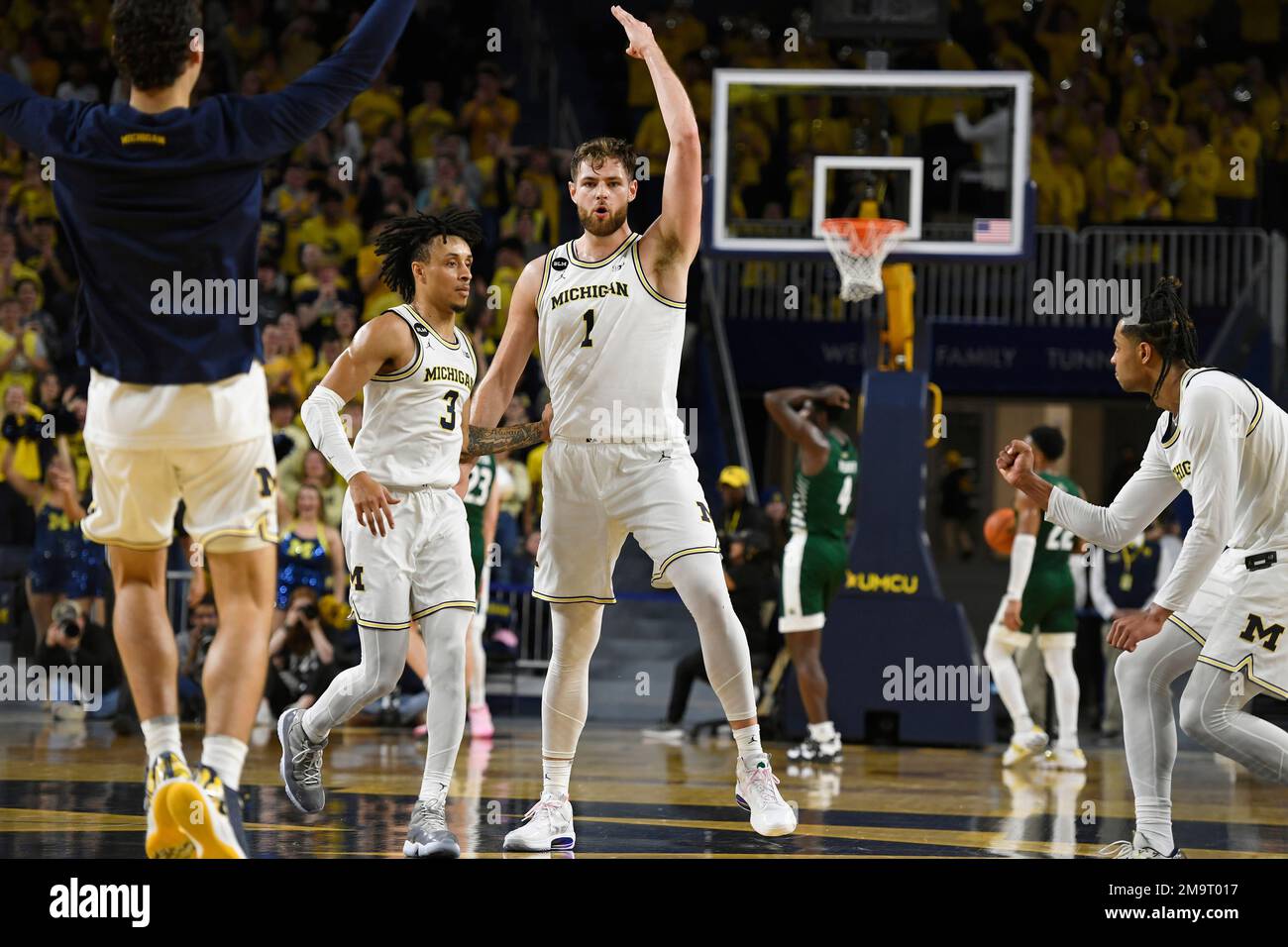 Michigan center Hunter Dickinson (1) reacts after making a 3-point ...
