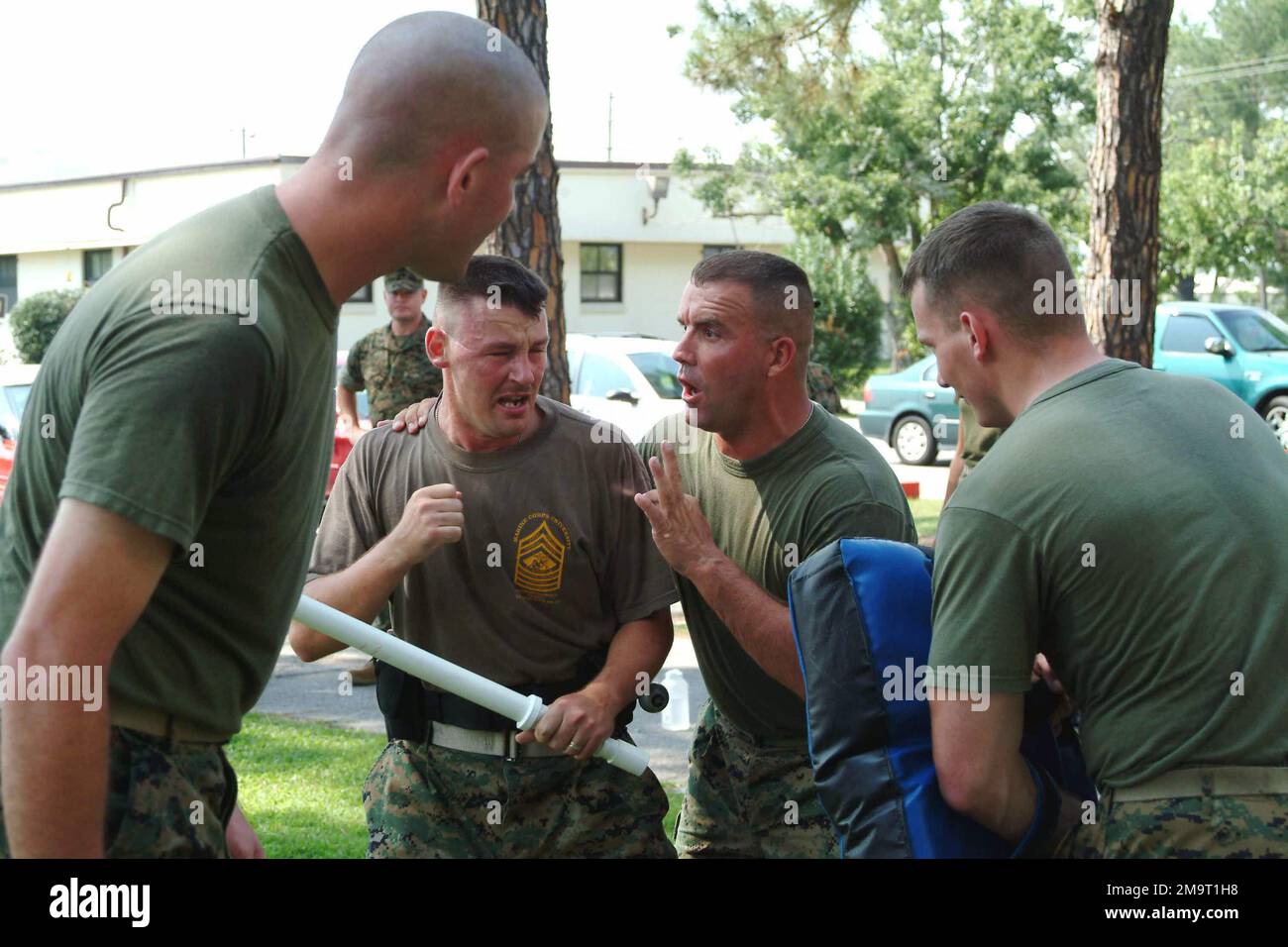 US Marine Corps (USMC) Sergeant (SGT) Robert Motsinger (center) is ...