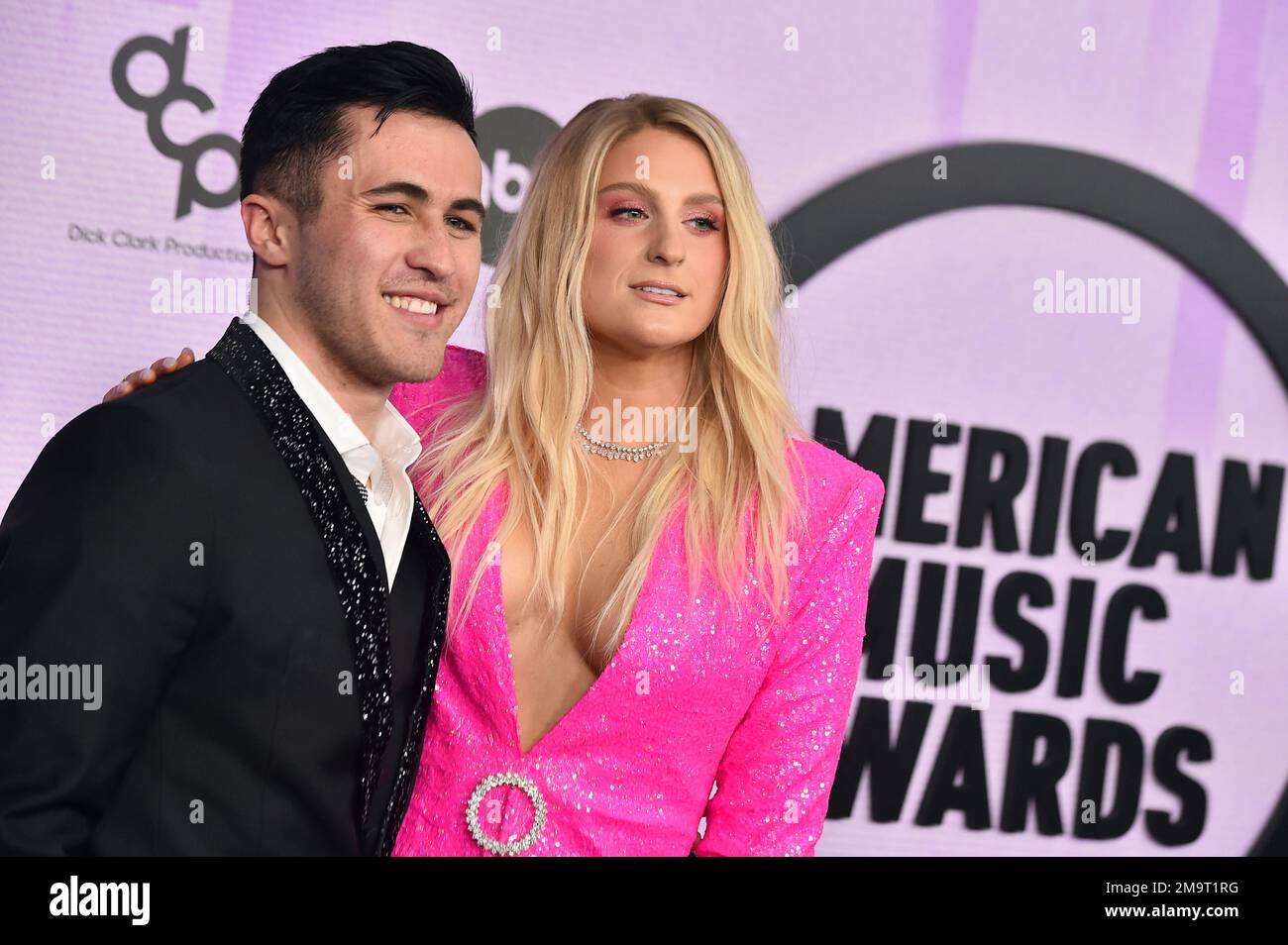 Christopher Olsen, left, and Meghan Trainor arrive at the American ...