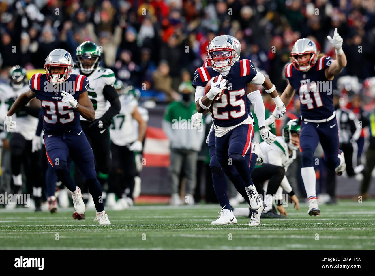 New England Patriots cornerback Marcus Jones (25) runs on this touchdown punt return during the ...