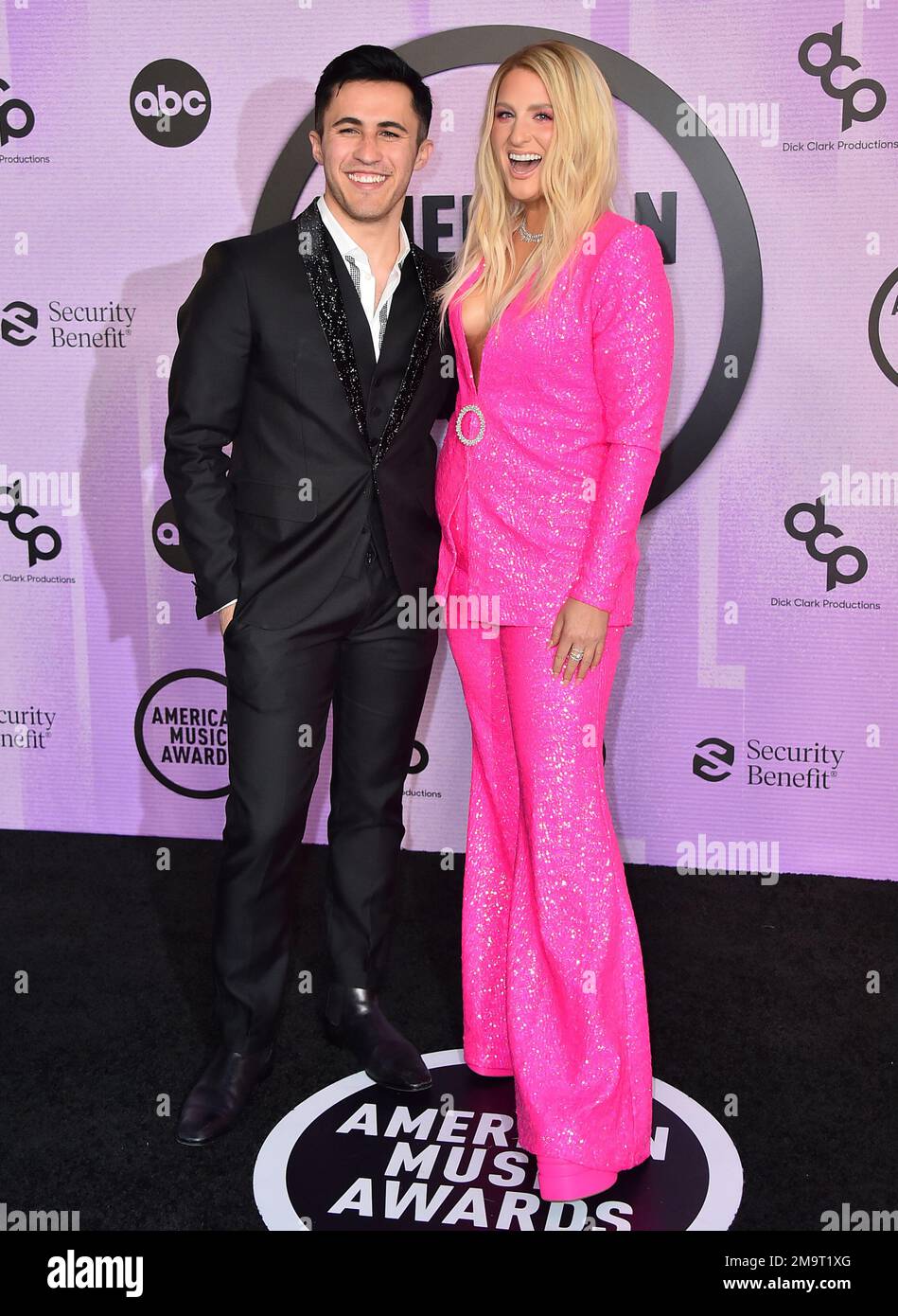 Christopher Olsen, left, and Meghan Trainor arrive at the American ...