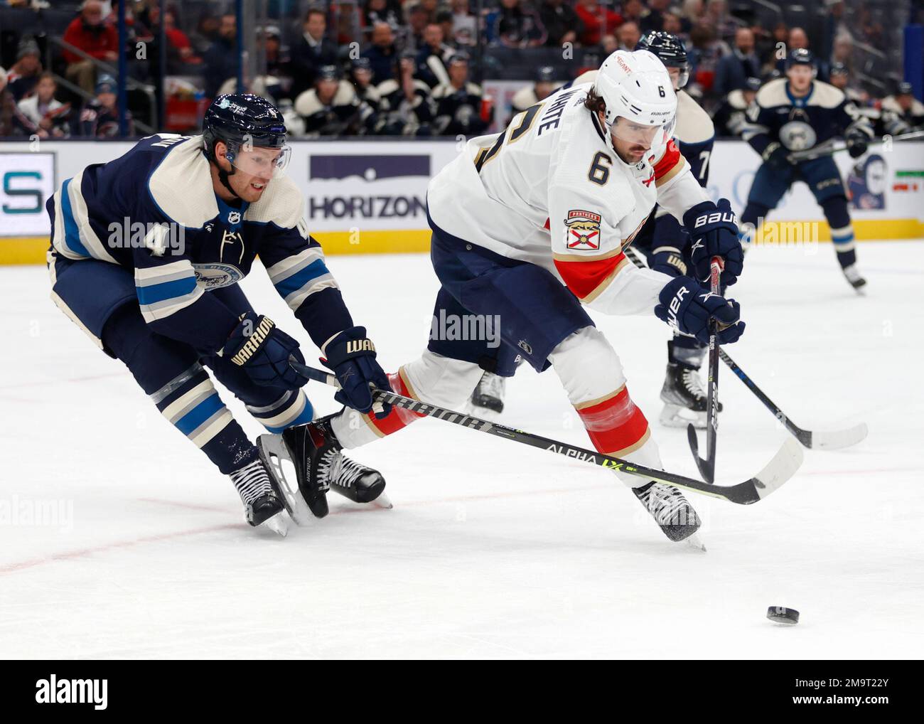 Florida Panthers forward Colin White, right, reaches for the puck in ...