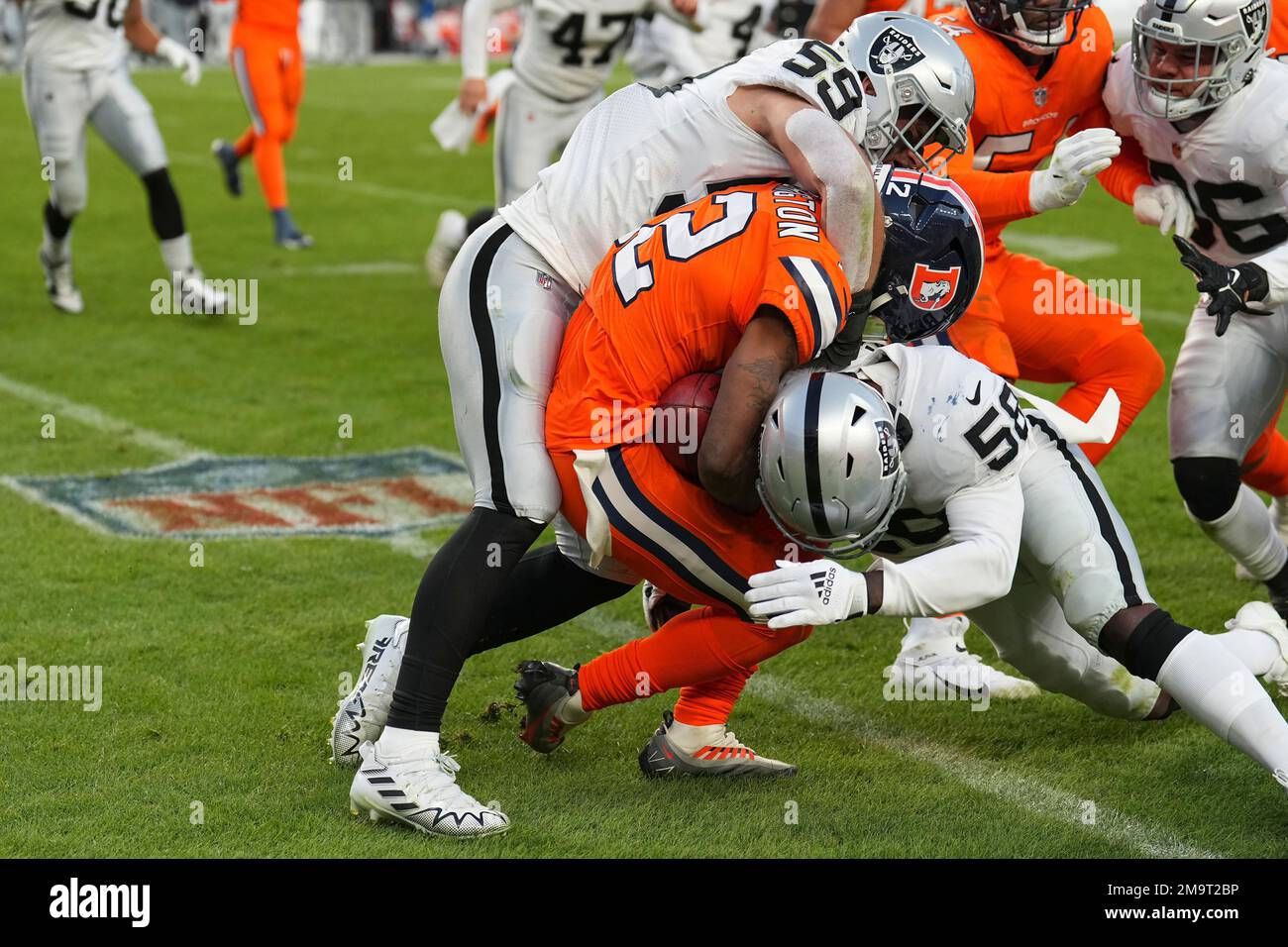 Denver Broncos' Montrell Washington, middle, is tackled by Las Vegas ...