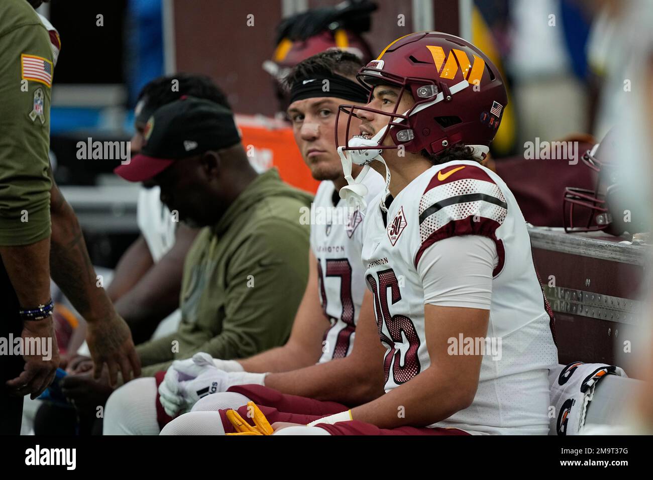 Washington Commanders tight end Cole Turner (85) sits on the bench ...