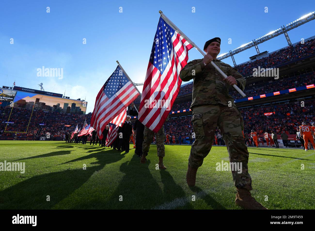 Members of the military carry flags before an NFL football game between ...
