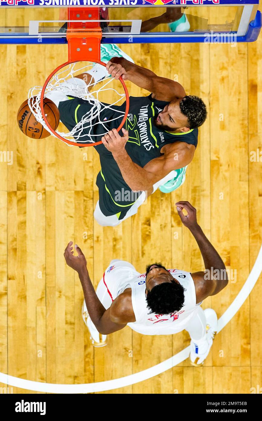 Minnesota Timberwolves' Rudy Gobert, top, dunks the ball as Philadelphia 76ers' Joel Embiid ...