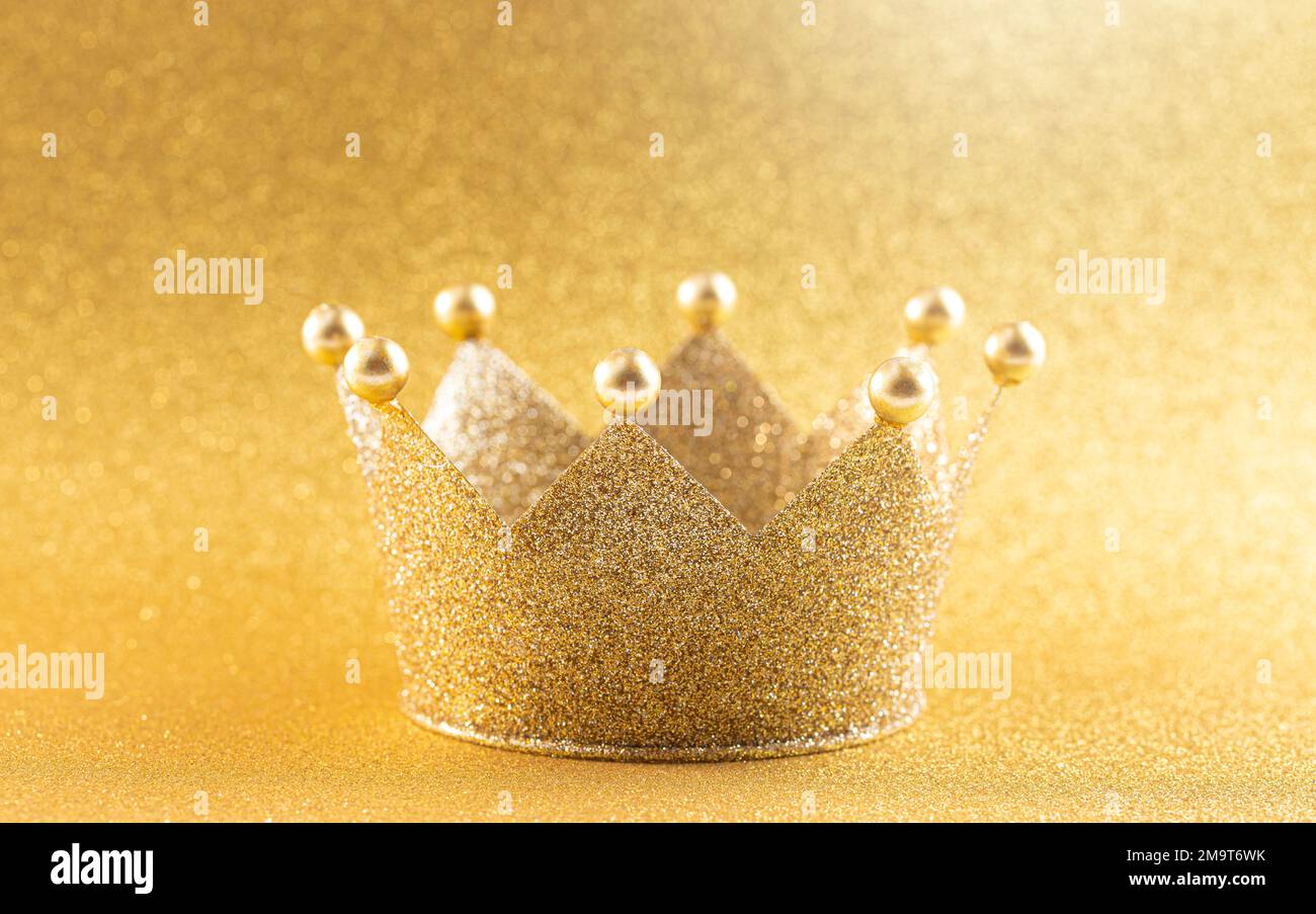 A Classic Golden Crown on a Golden Background Stock Photo - Alamy