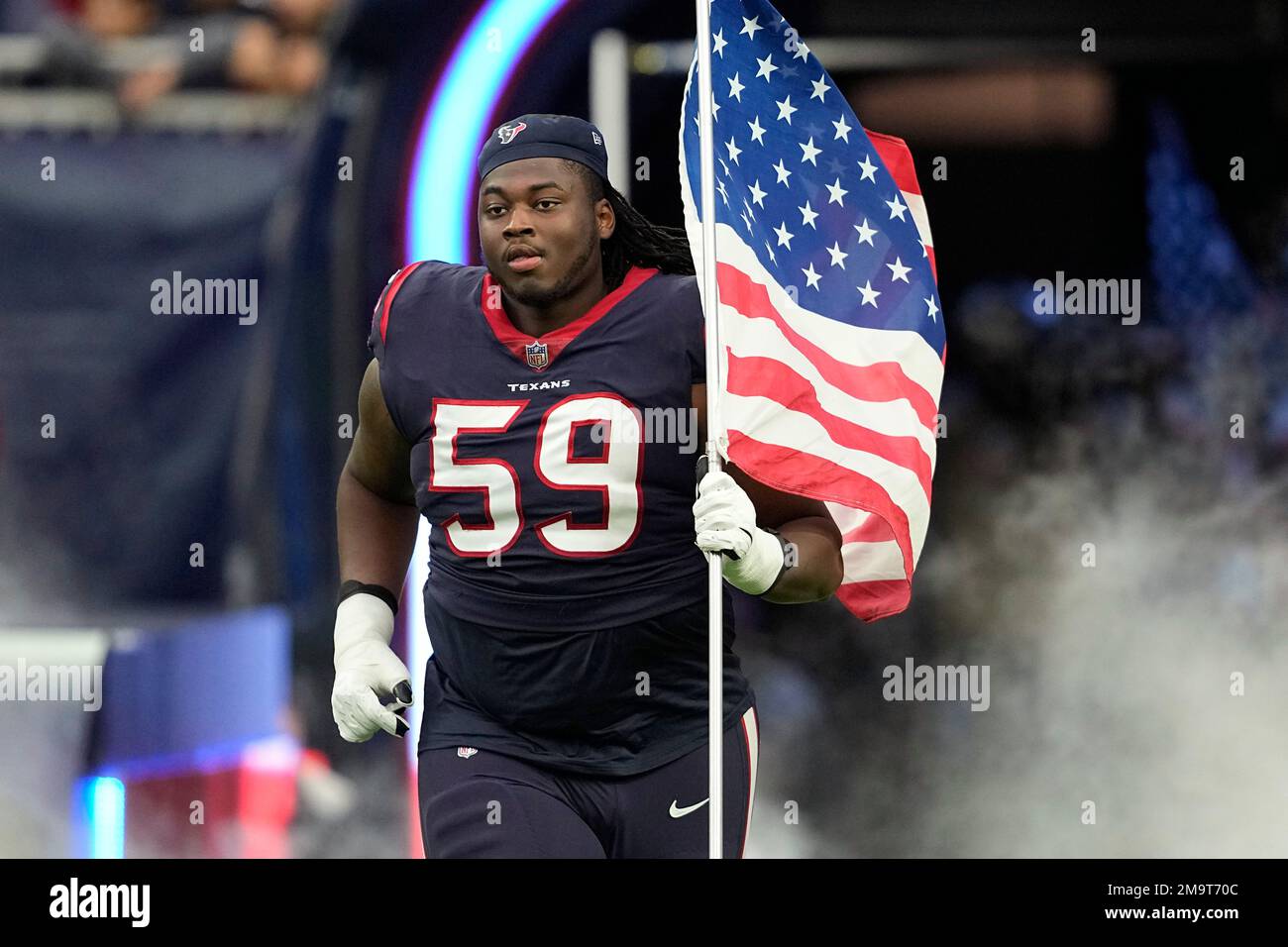 Houston Texans guard Kenyon Green (59) runs on to the field with a flag ...