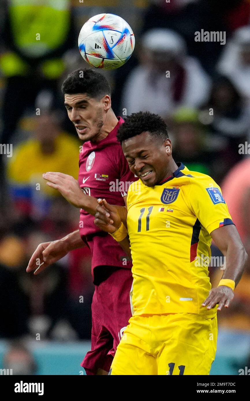 Qatar's Karim Boudiaf and Ecuador's Michael Estrada (11) go for a ...