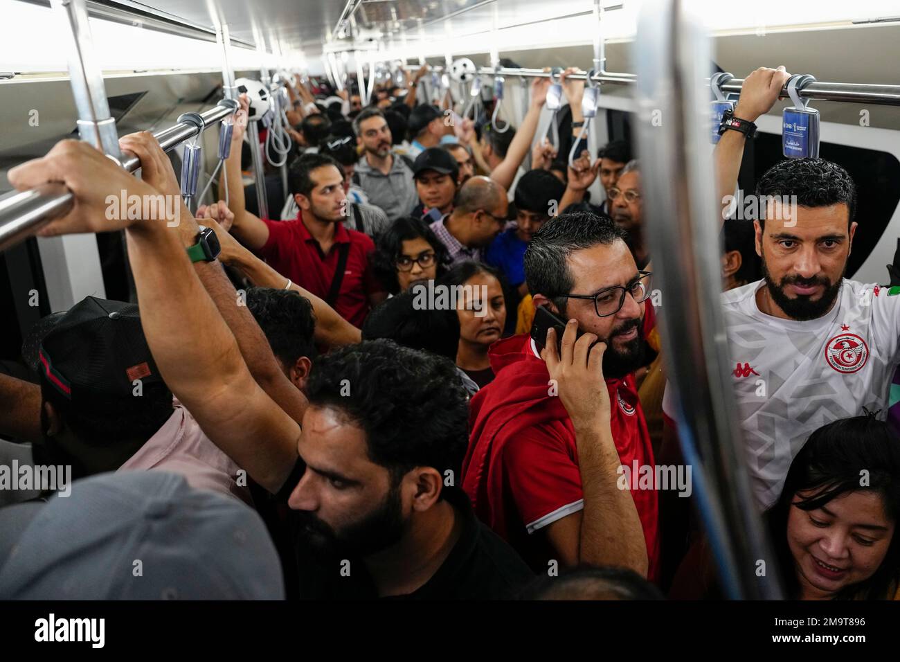 Fans ride a subway train ahead of the World Cup group A soccer match ...