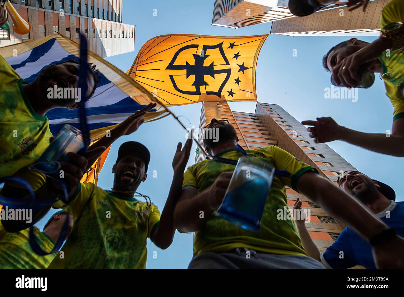 Brazilian fans take part in the hoisting of two large Brazilian soccer ...