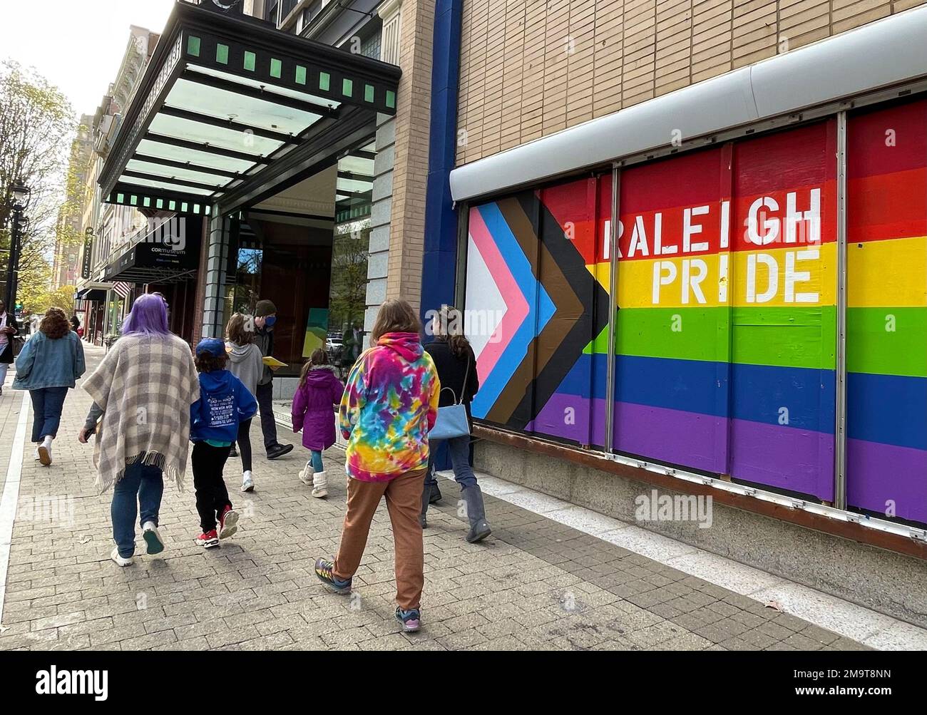 A family walks by an LGBTQ pride mural in downtown Raleigh, North ...