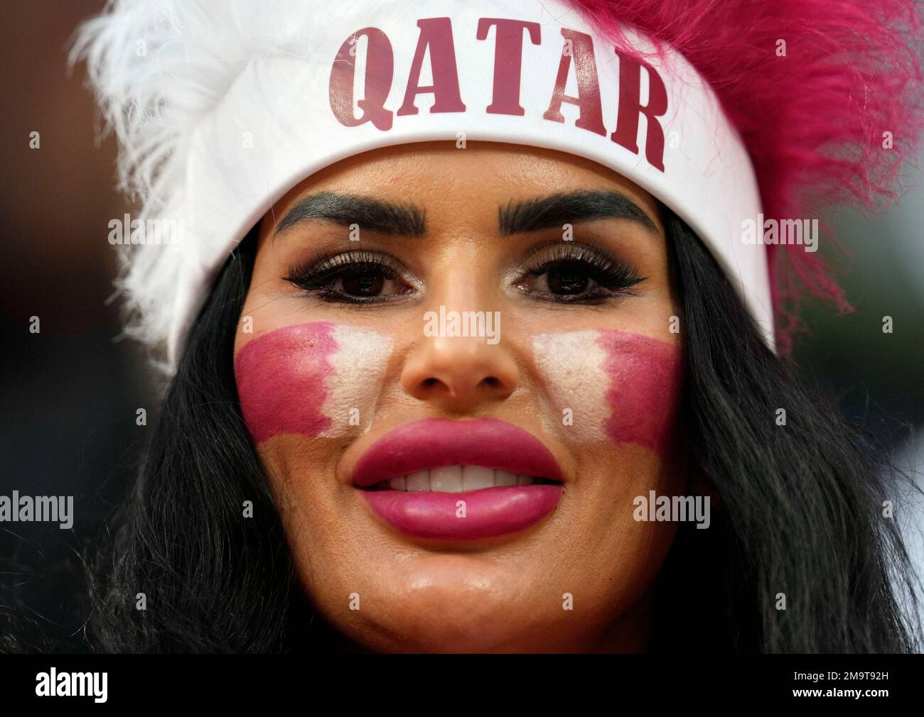A female Qatar fan smiles to the camera prior he World Cup, group A ...