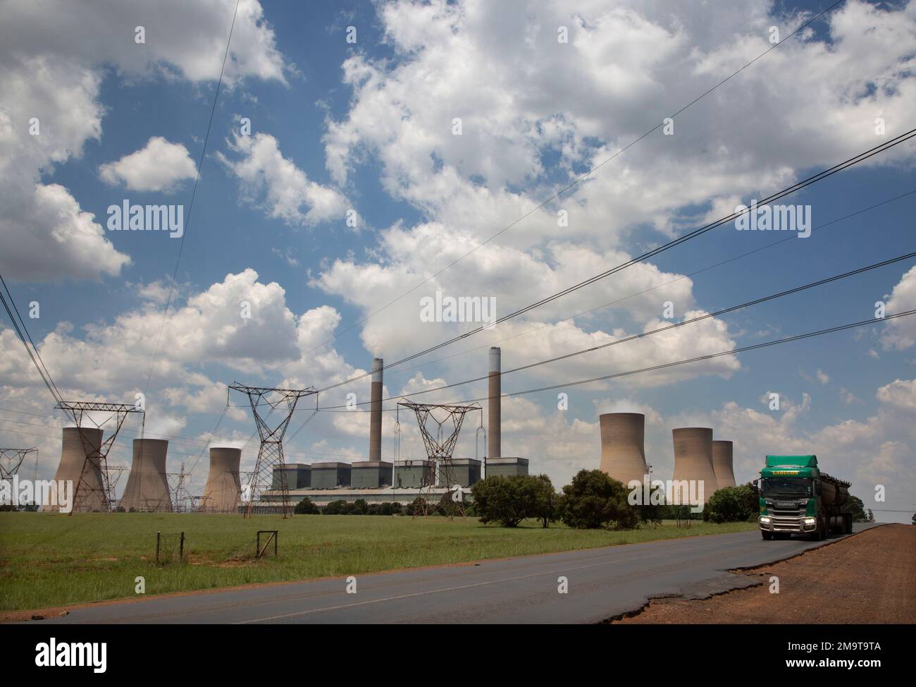 A coal truck, right, passes the coal-powered Duvha power station, near ...