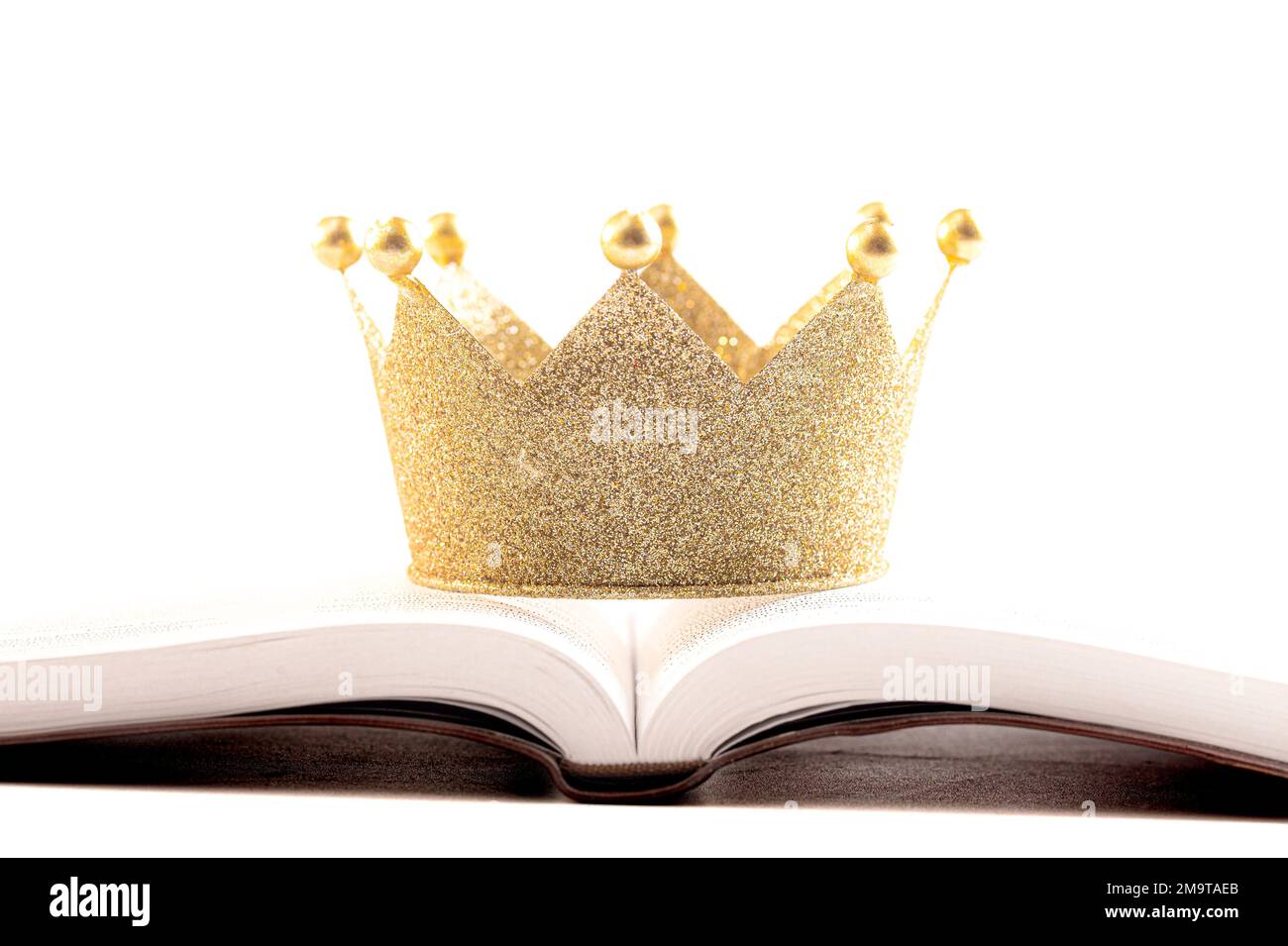 A Golden Crown on a Holy Bible Isolated on a White Background Stock ...