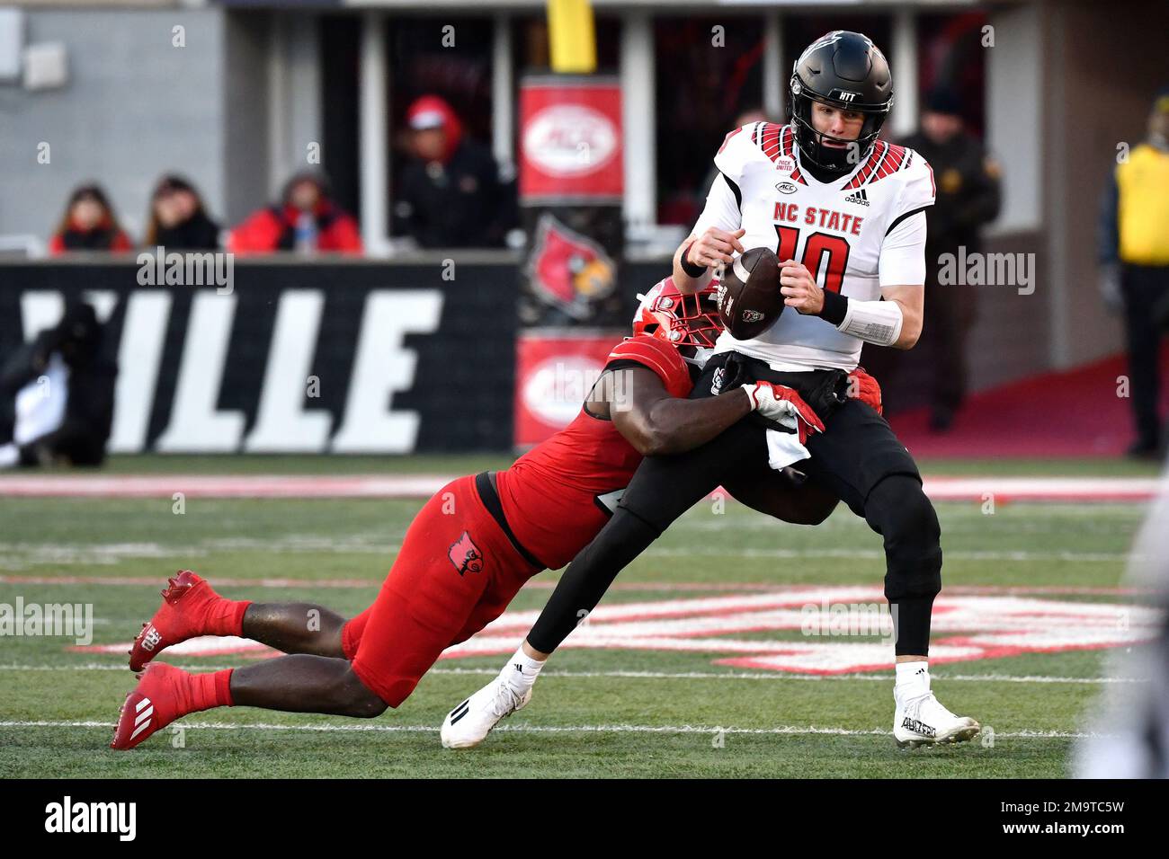 North Carolina State quarterback Ben Finley (10) is brought down by ...