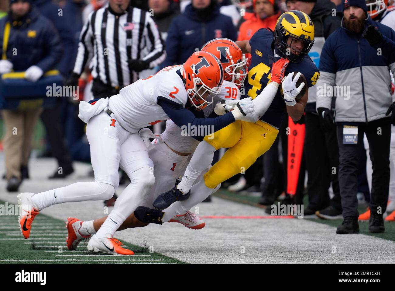 Michigan running back Isaiah Gash (41) is knocked out of bounds by ...