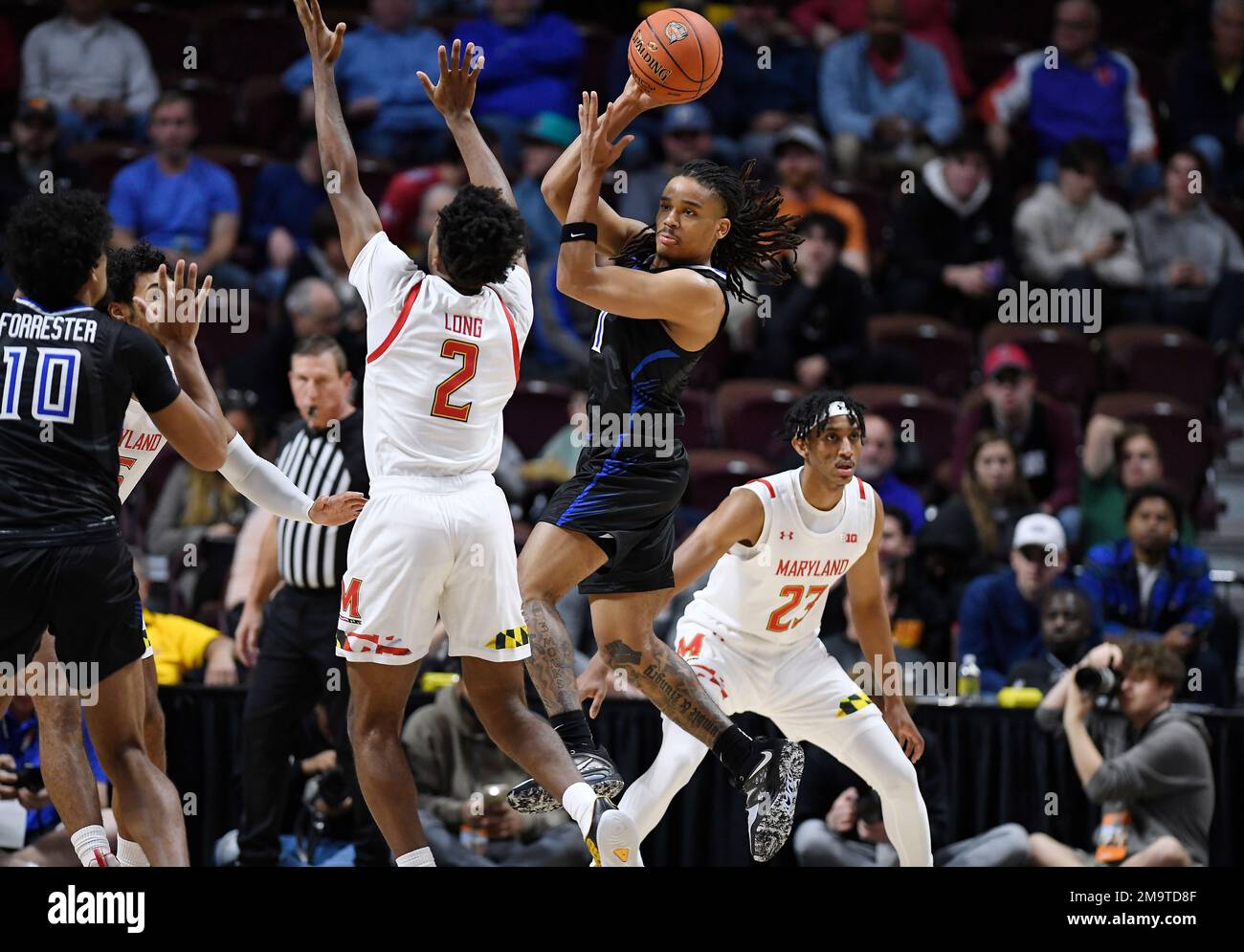 Saint Louis guard Yuri Collins, center, looks to pass as Maryland guard ...