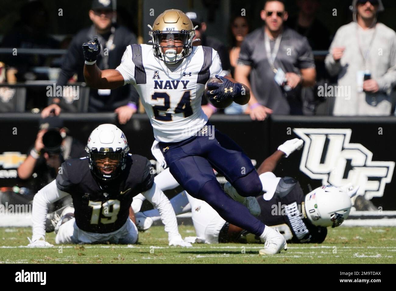 Navy's Maquel Haywood (24) returns a kickoff against Central Florida ...