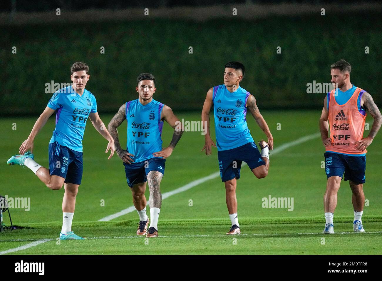 Julian Alvarez, Enzo Fernandez, Thiago Almada and Alexis Mac Allister stretch during a training ...
